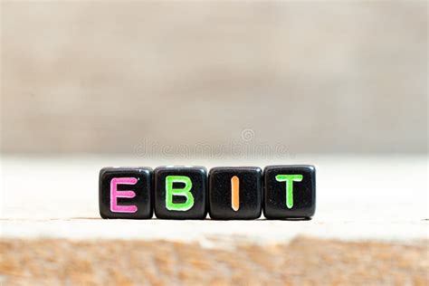 Black Bead With Letter In Word Ebit Abbreviation Of Earnings Before Interest And Taxes On Wood
