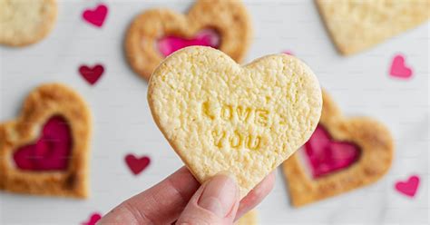 A Person Holding A Heart Shaped Biscuit In Their Hand Photo Valentines Image On Unsplash