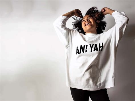 Download Joyful Woman Wearing Aniyah Sweatshirt Wallpaper