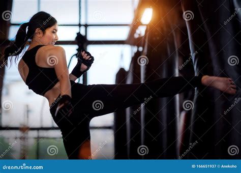 Asian Girl Kick A Sand Bag In Kickboxing Gym Stock Image Image Of