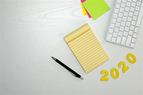 free photo yellow notepad pen and keyboard