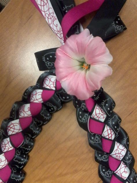 Black Pink And White Hello Kitty Graduation Ribbon Lei With Pink Flower Close Up Pink Hello