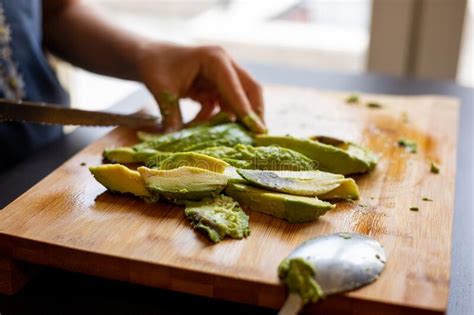 Cutting Avocado On Wooden Board Closeup At Home Stock Image Image Of