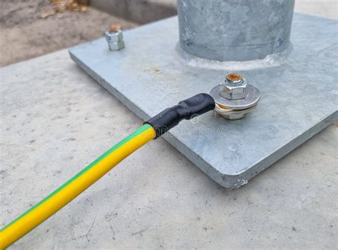 Electrical Grounding Or Earthing Wire At A Zinc Plated Steel Pole Stock