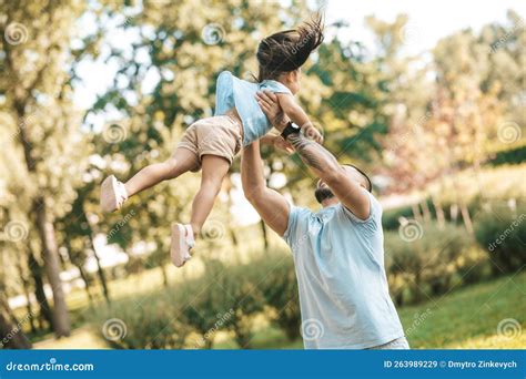 Dad And Daughter Having Fun In The Park And Looking Enjoyed Stock Image