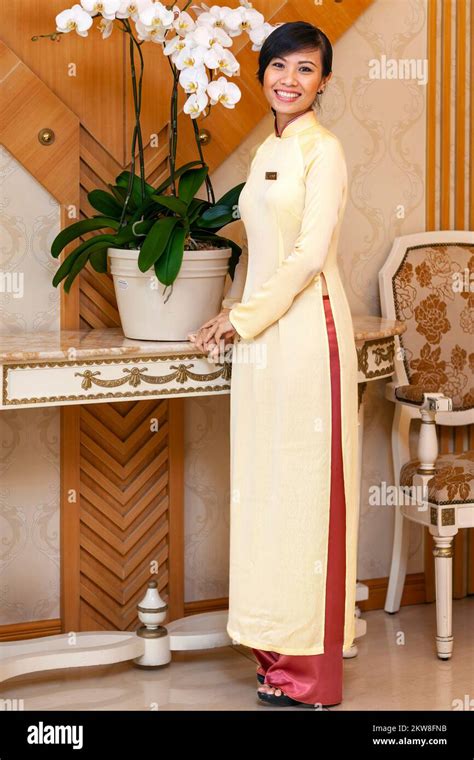 Vietnamese Hotel Receptionist Posing For Portrait Wearing Ao Dai Ho