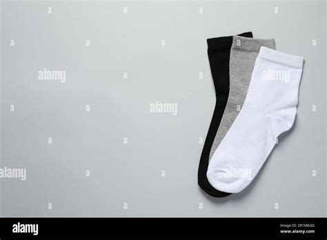 Different Socks On Light Grey Background Flat Lay Space For Text