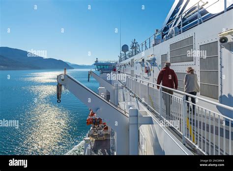 Tourist People Walking On Deck Of A Cruise Ferry Ship Along The Inside