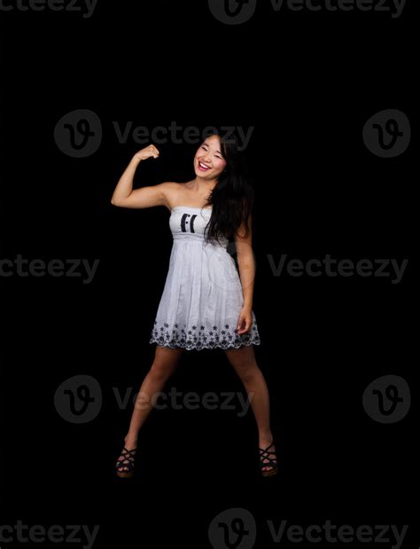 Japanese American Woman Showing Biceps In Dress Black Background