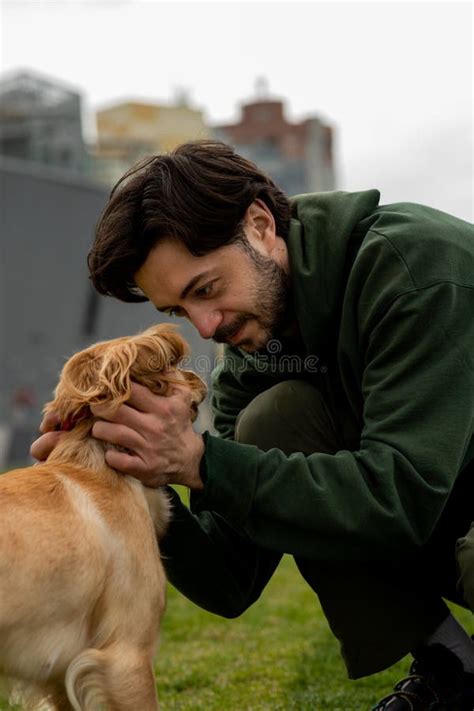 The Man Leaned Over To The Cocker Spaniel And Scratched Behind His Ears