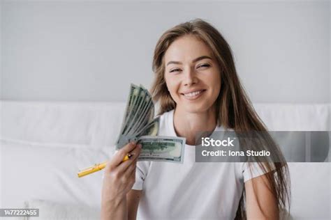 Happy Blonde Italian Girl In White Tshirt Toothy Smiles Holds Dollar