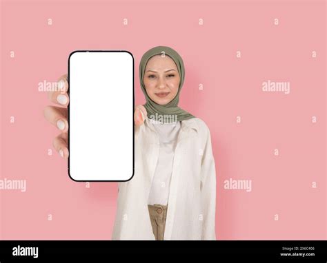 Portrait Of Muslim Woman Showing Empty Blank White Screen Mobile Phone Mock Up Application