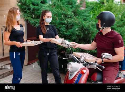 Two Womans Pick Up Delivery Food Box From Delivery Rider With Scooter
