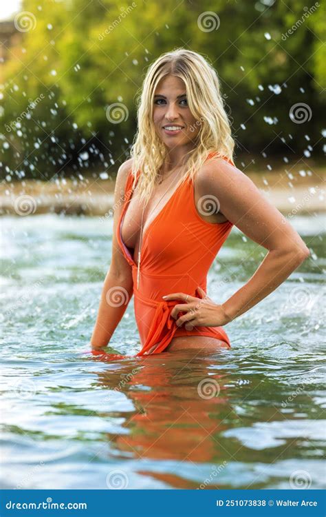 A Lovely Blonde Bikini Model Enjoys The Summer Weather On A Lake Stock
