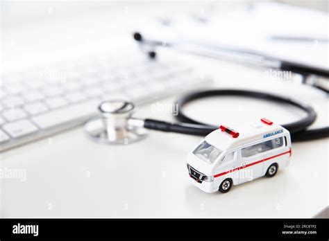 A Stethoscope In Front Of A Computer And A Miniature Ambulance Stock