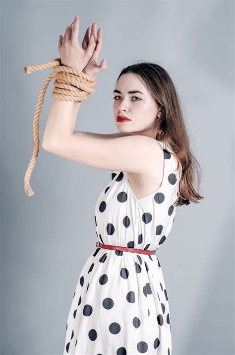 Portrait Of A Beautiful Woman Dressed In A Polka Dot Dress Hands Tied