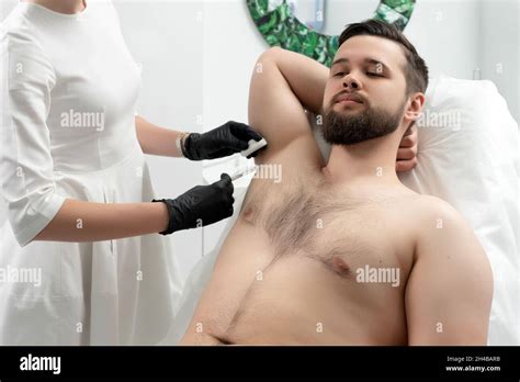 Doctor Doing Injection From Hyperhidrosis Man Receiving An Underarm