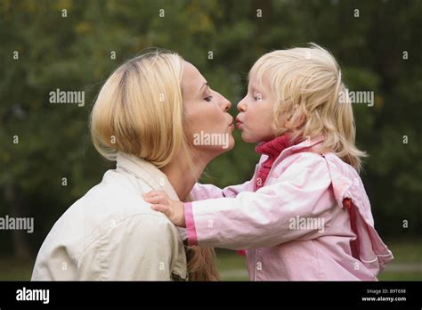 Girl And Mother Kiss Stock Photo Alamy