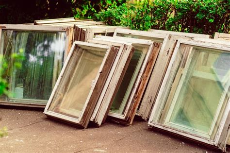 Premium Ai Image Bunch Of Old Wooden Windows Frames On The Street Replacement Of Windows