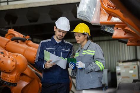 Engineers Working Robot Assembly Industry Plant In Factory Examining Condition Inspection
