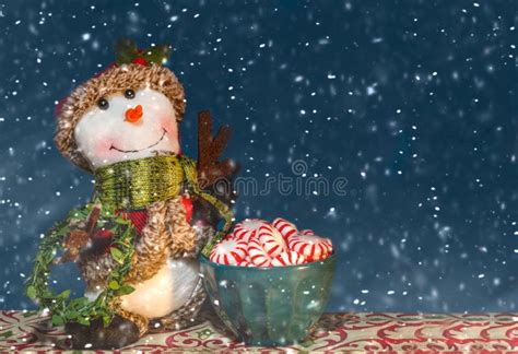 Snowman With Peppermint Candy On Dark Blue Background Stock Image