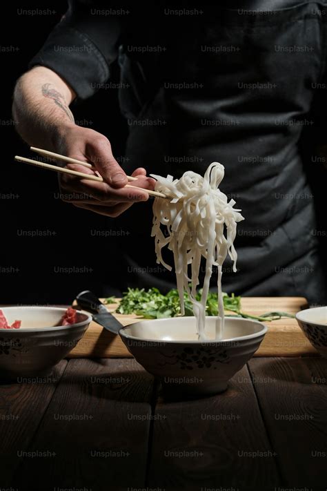 Close Up Of Chefs Hands Picking Noodles From The Bowl Photo Noodles Image On Unsplash