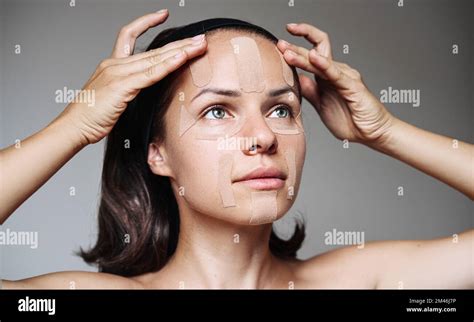 Young Adult Woman Applying Facial Kinesiology Tape On Her Face Facial