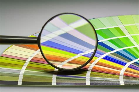 Close Up Of Magnifying Glass Over Color Swatches Premium Photo