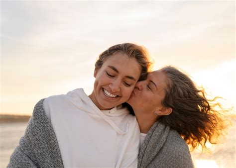 Free Photo Front View Mother Kissing Daughter On Cheek