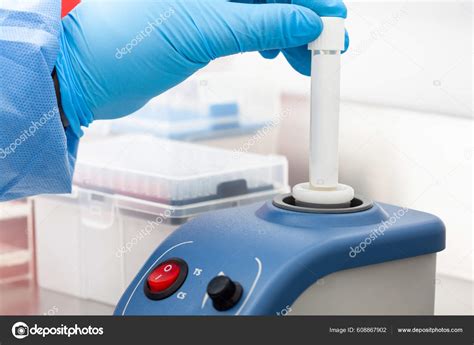Scientist Mixes Biological Sample Analysis Using Lab Vortex Mixer