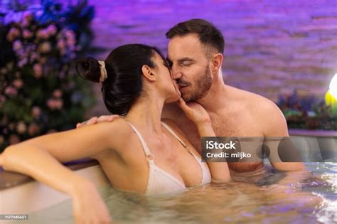 Mid Adult Couple Enjoying Together In Spa Center With Hot Tub Stock