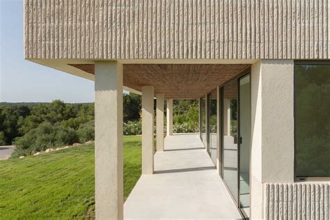 Fluted Concrete Walls Cut By Continuous Window Openings Define This Villa