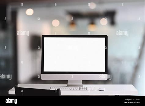 Workspace Computer Monitor With A White Blank Screen On White Table