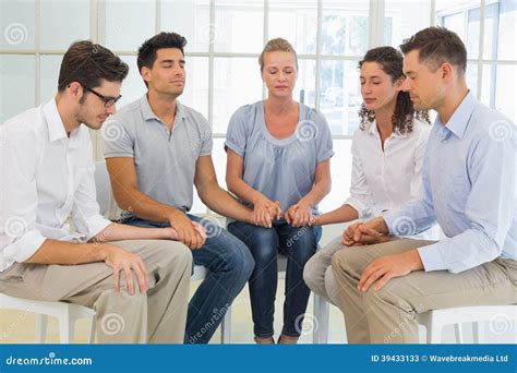 Group Therapy In Session Sitting In A Circle Holding Hands Stock Image