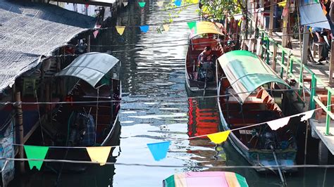 Boats Move Through A Bustling Canal Market Premium Stock Video Footage