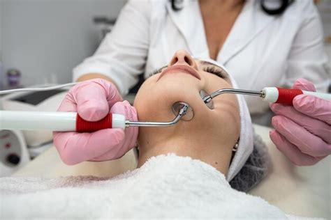 Premium Photo Young Pretty Woman Receiving Facial Performing Microcurrent Stimulation