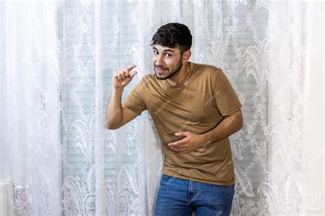 Premium Photo Man Making Small Gesture With Fingers On A White Background