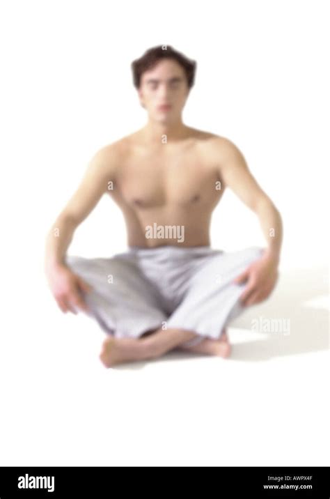 Topless Man Sitting On Floor Indian Style Meditating Blurred Stock