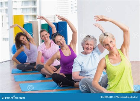 Women Practicing Stretching Exercise In Gym Class Stock Image Image