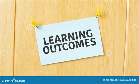 Learning Outcomes Sign Written On Sticky Note Pinned On Wooden Wall