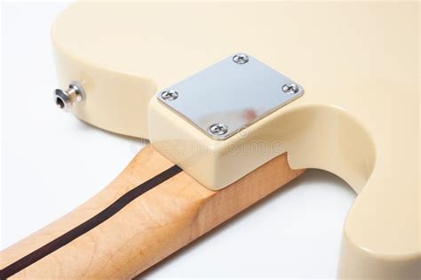 Six String Electric Guitar With A Cream Colored Wooden Body And Chrome