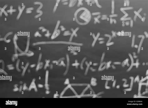 Blurred Maths Formulas Written By White Chalk On The Blackboard