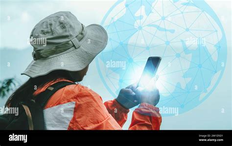 Female Ecologists Carry A Backpack Using A Map On The Phone To Explore