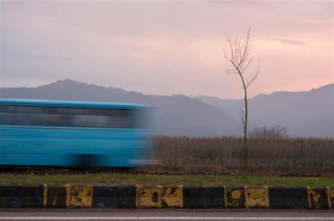 Premium Photo Blue Mini Bus Vehicle Moving Through Road Slow Shutter Speed Photography