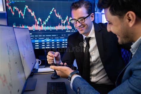 traders comparing dynamic investment graph via phone and pc sellable