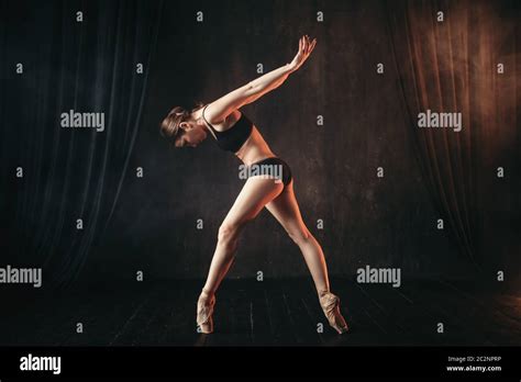 Classical Ballet Dancer In Black Practice Training On The Stage Graceful Ballerina Poses In