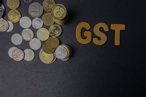 Premium Photo Directly Above Shot Of Gst Text With Coins On Black Background