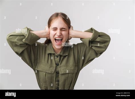Photo Of Annoyed Young Woman Screaming And Grabbing Her Head Isolated