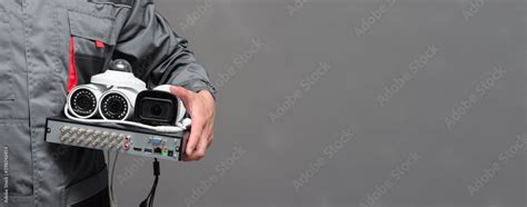 Cctv Camera And Video Surveillance Equipment In The Worker Hands On The