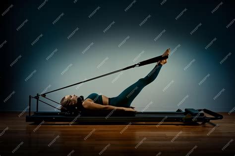 Premium Photo Young Girl Doing Pilates Exercises With A Reformer Bed